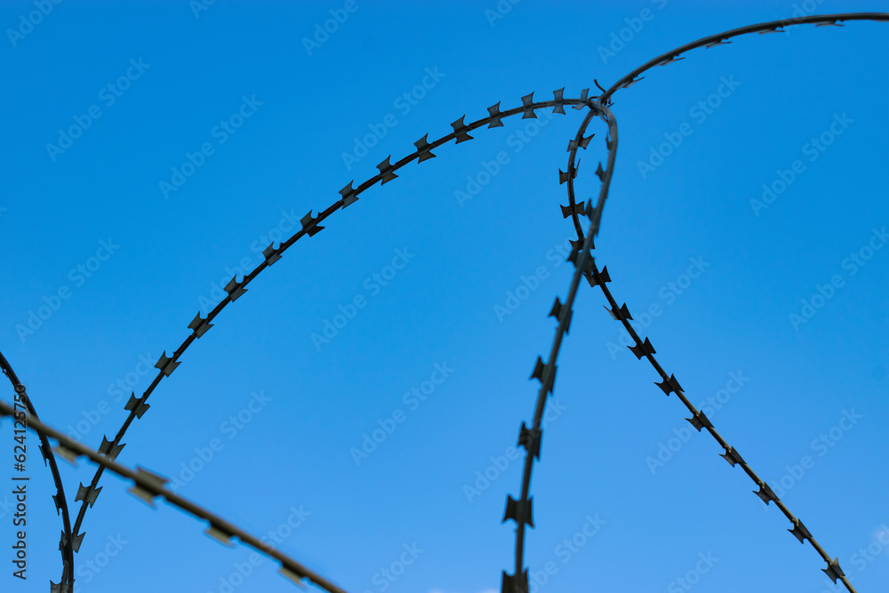 barbed wire on a concrete fence. concept prison, border, penetration ...
