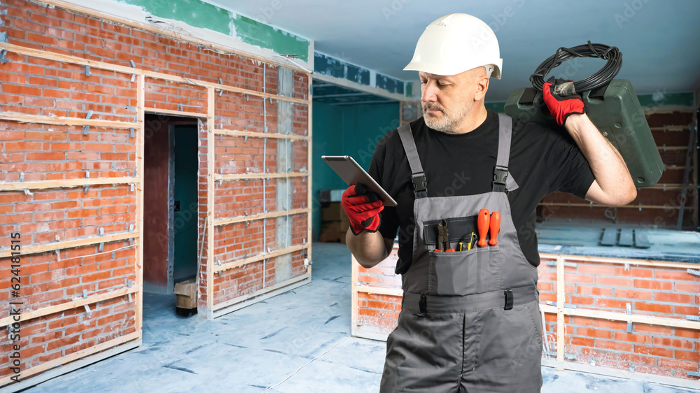 Man builder. Worker in building under construction. Builder is holding ...