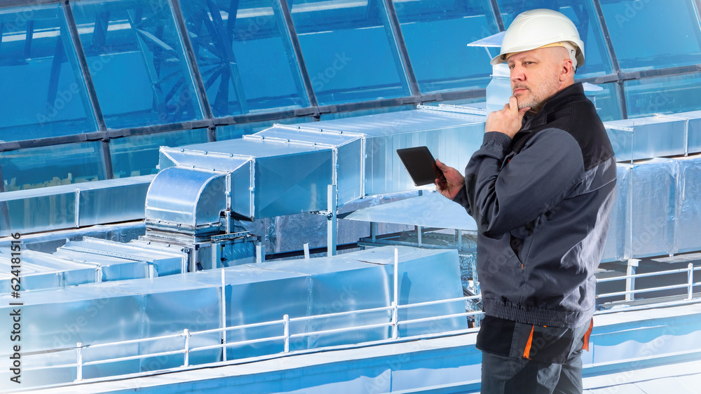 Man engineer. Ventilation shafts. Worker with tablet thought. Control ...