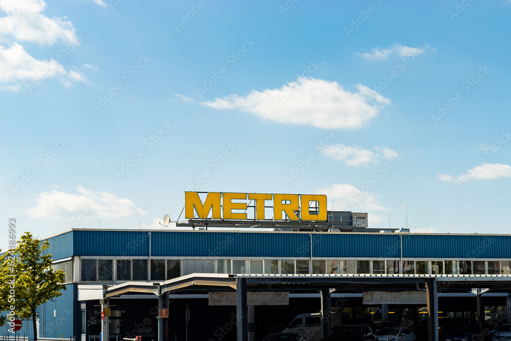 DRESDEN, GERMANY - 24. June 2023: Metro logo sign on top of the blue ...