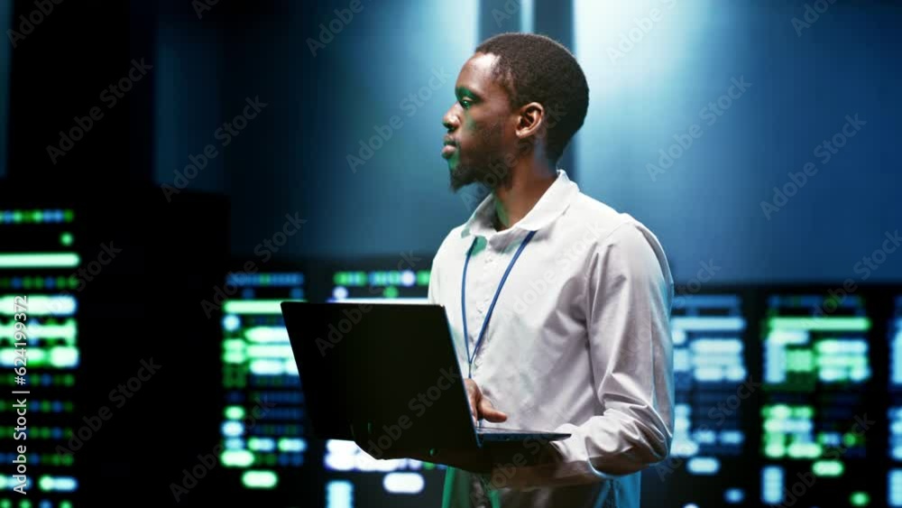 IT programmer setting up high tech facility advanced firewalls, intrusion detection systems and ...