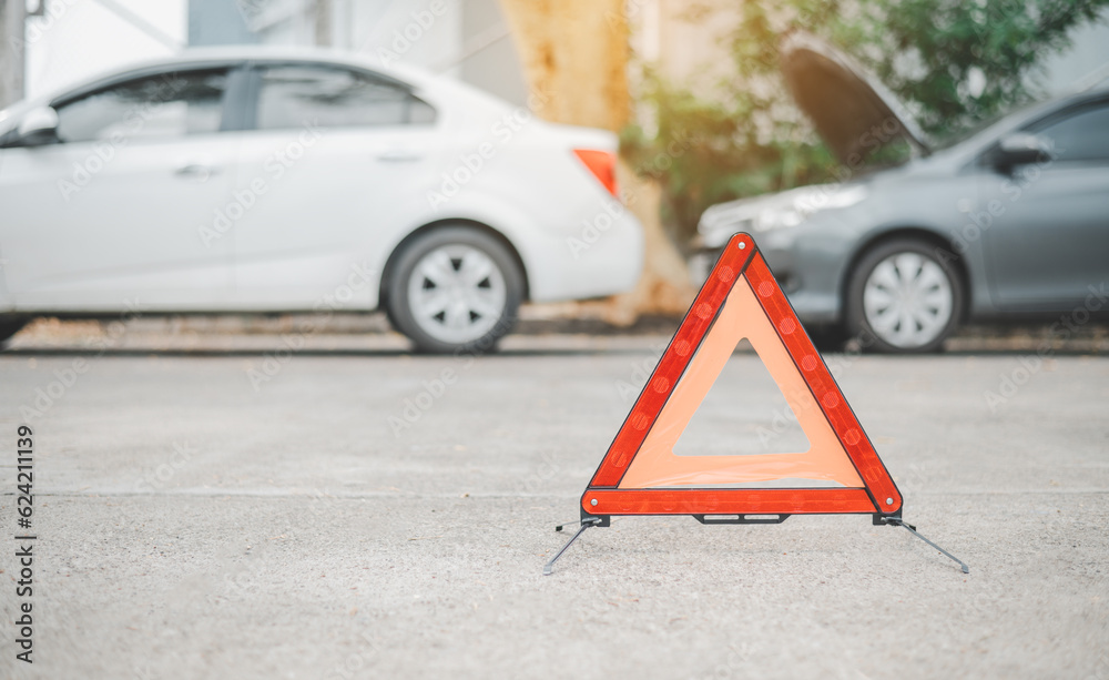 red emergency triangle on the road indicates that there is an accident ...