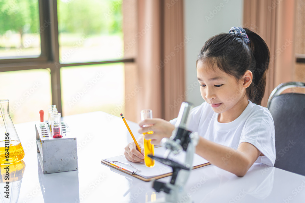 little scientist looking through a microscope and test tubes filled ...