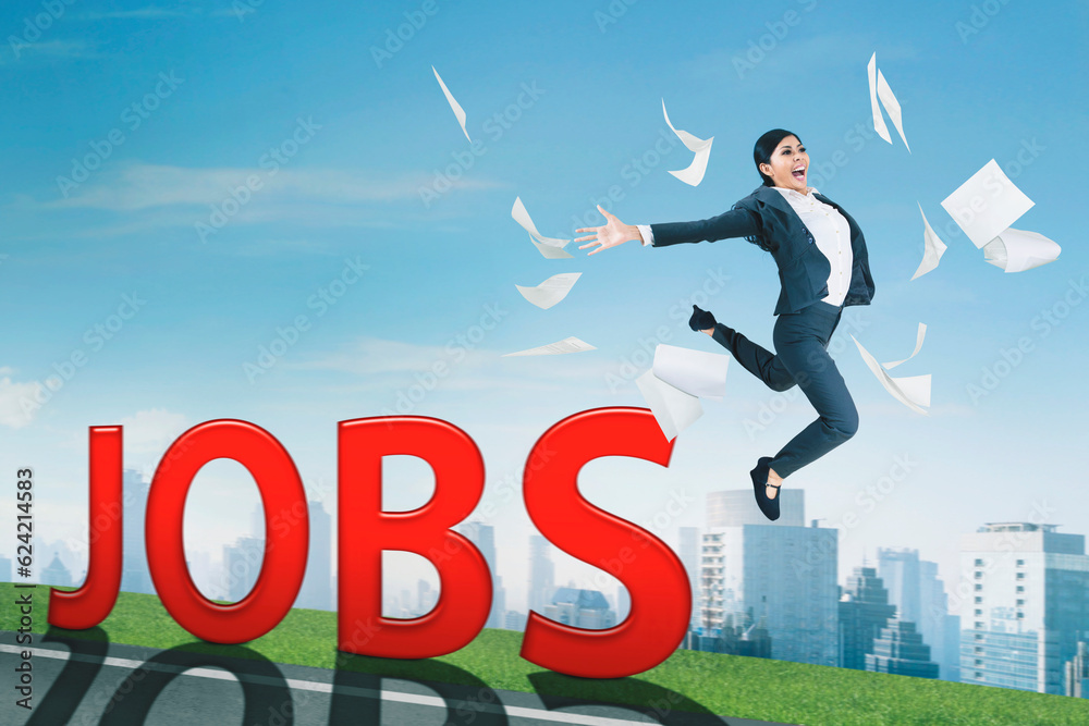 Asian businesswoman jumping and throwing papers into air with lettering ...