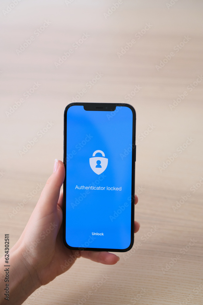 Hand holding smartphone with Microsoft Authenticator logo on November 4 ...