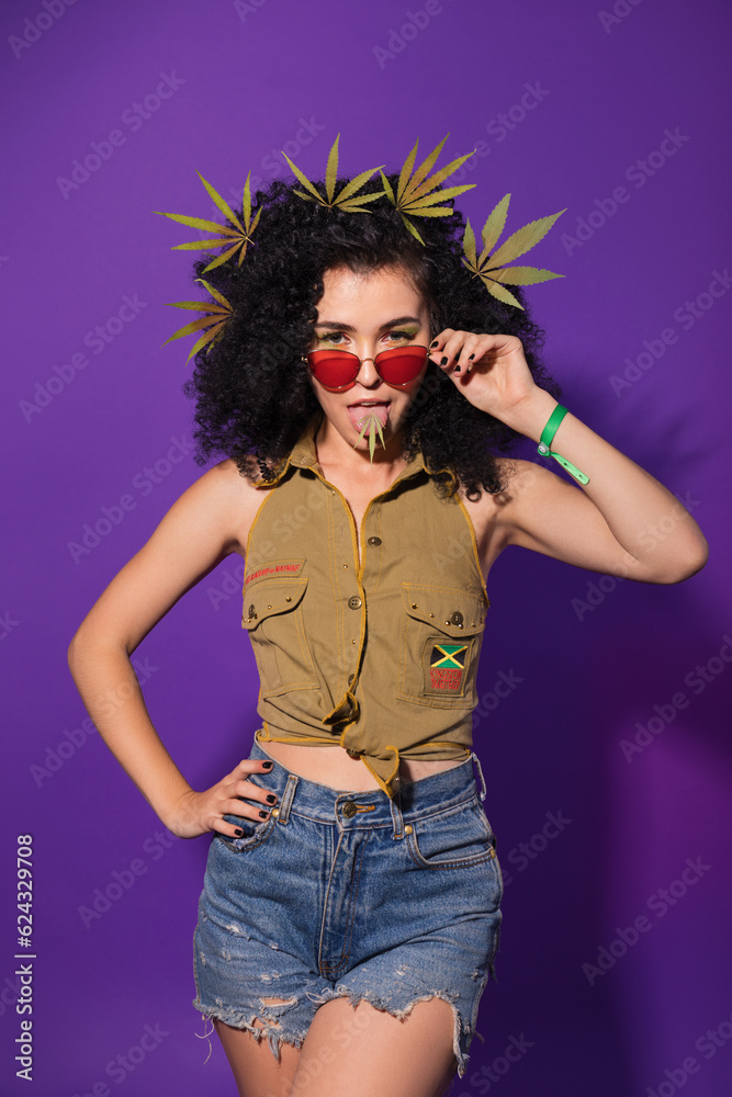 Beautiful rastafarian woman in red sunglasses with marijuana leaves in ...