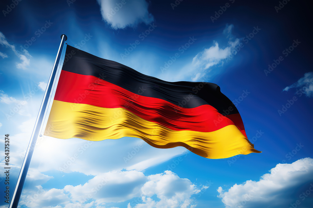 Germany flag flying in the wind on a flagpole against a blue sky with ...