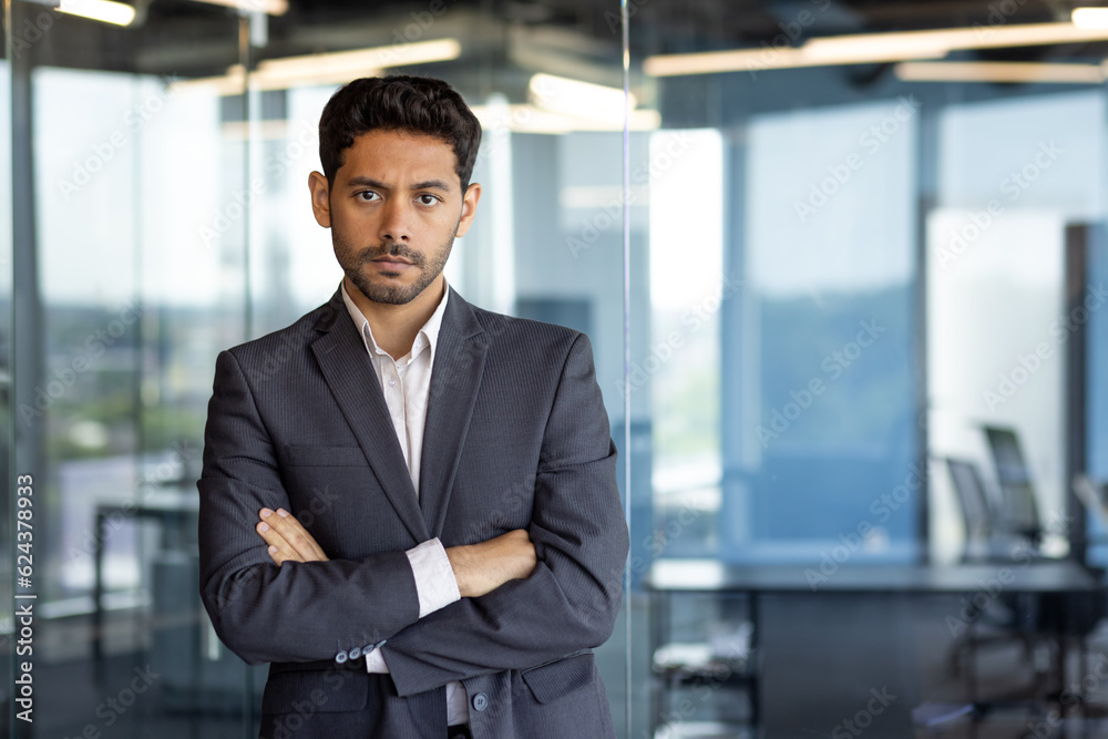 Portrait of mature serious businessman, arab with crossed arms thinking ...