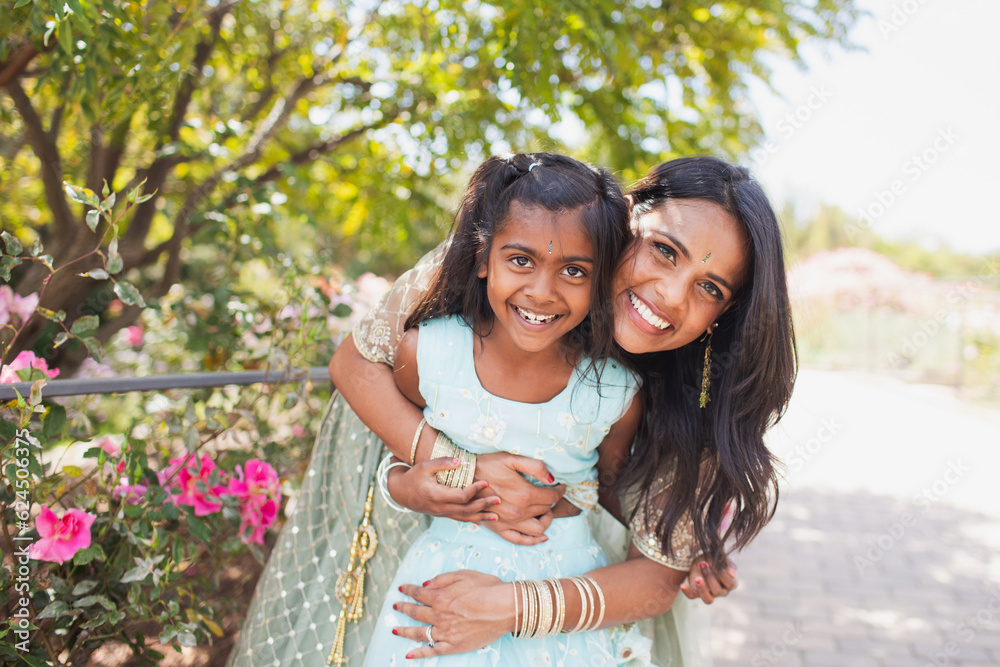 beautiful indian mother and daughter hugging in close with a bindi and ...