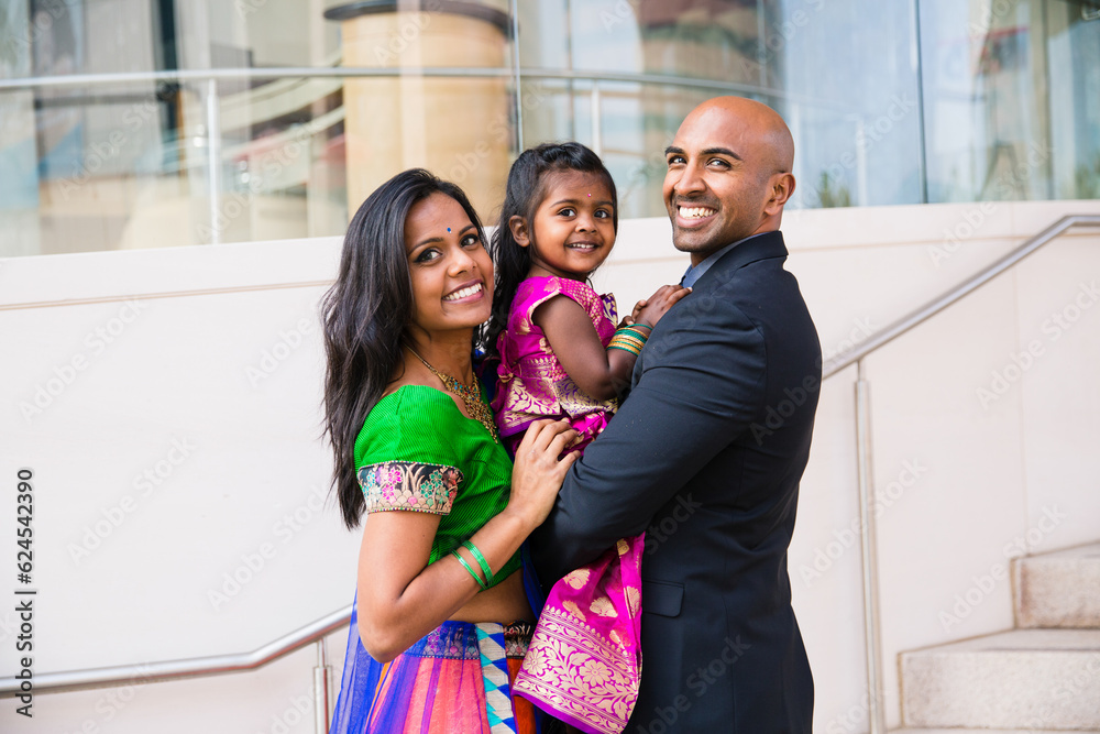 beautiful indian family with daughter girl hugging and smiling with a ...