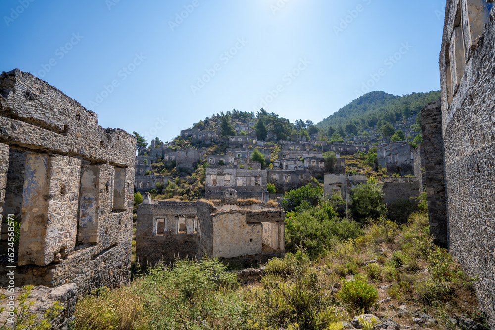 Ancient Greek house ruins in the ghost town of Kayakoy. Kayakoy is ...