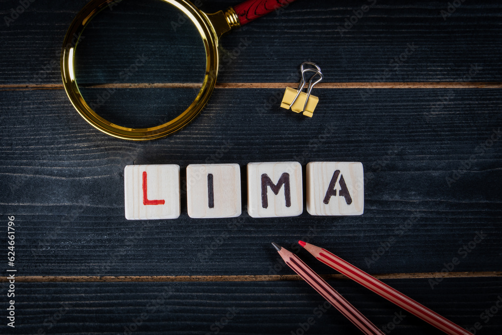 LIMA. City name from alphabet letters on dark wood texture background ...