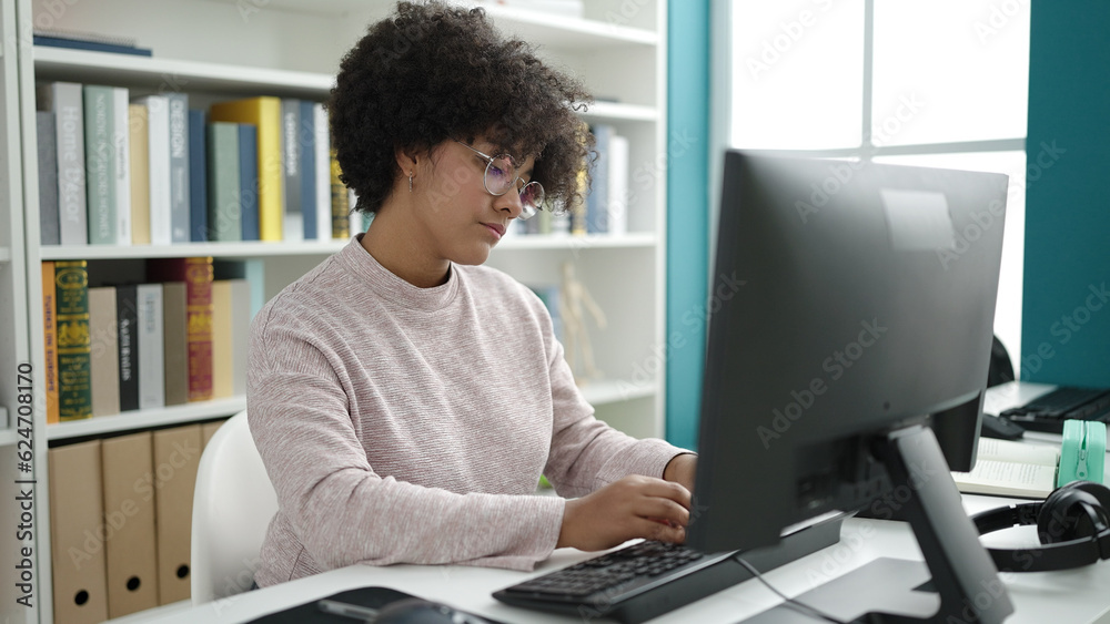 Young african american woman student using computer studying at ...