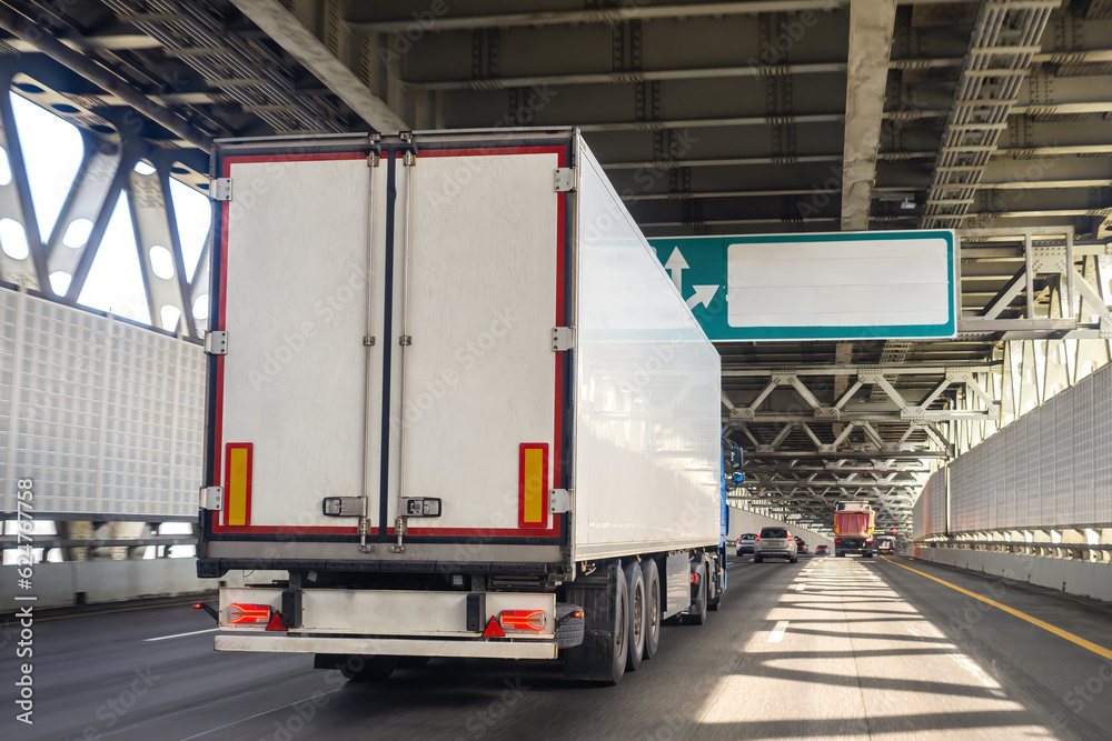 Lorry back view. Truck on highway. Lorry is carrying goods on road ...