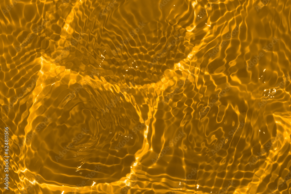 Gold watercolor with ripples on the surface. Defocus blurred ...