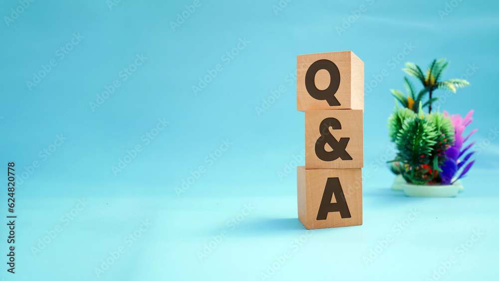 Q and A - Q and A abbreviations on wooden block surface with engraved ...