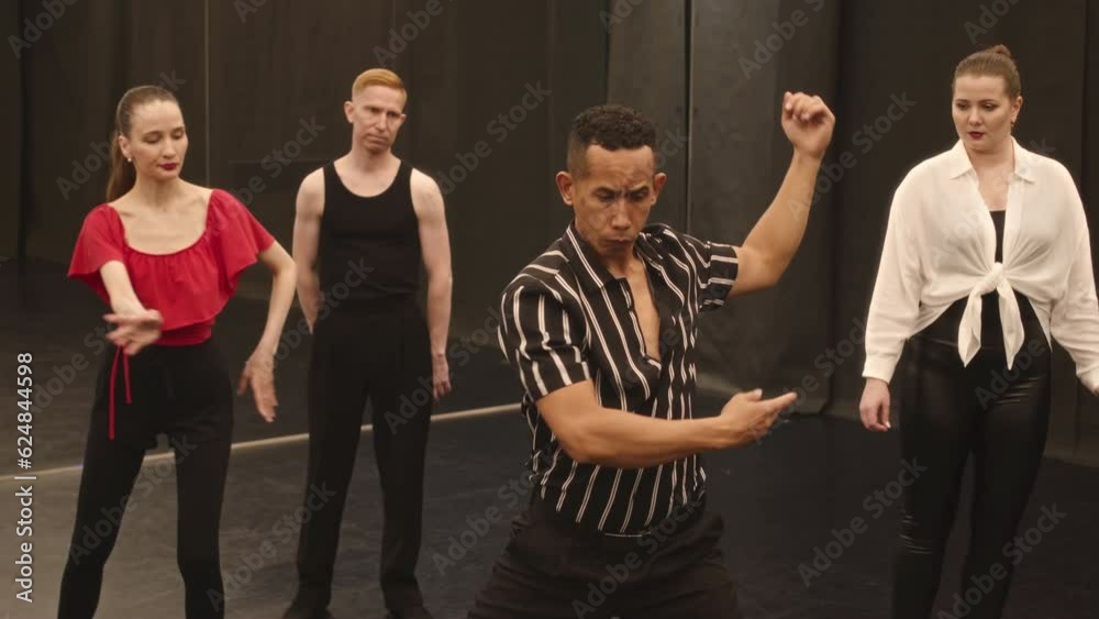 Medium slowmo of expressive Biracial male teacher giving tango dance ...