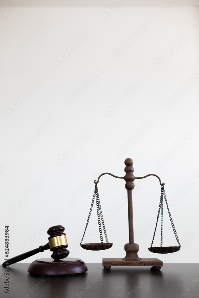 gavel wood and Brass court scales are used to decorate a table in a ...