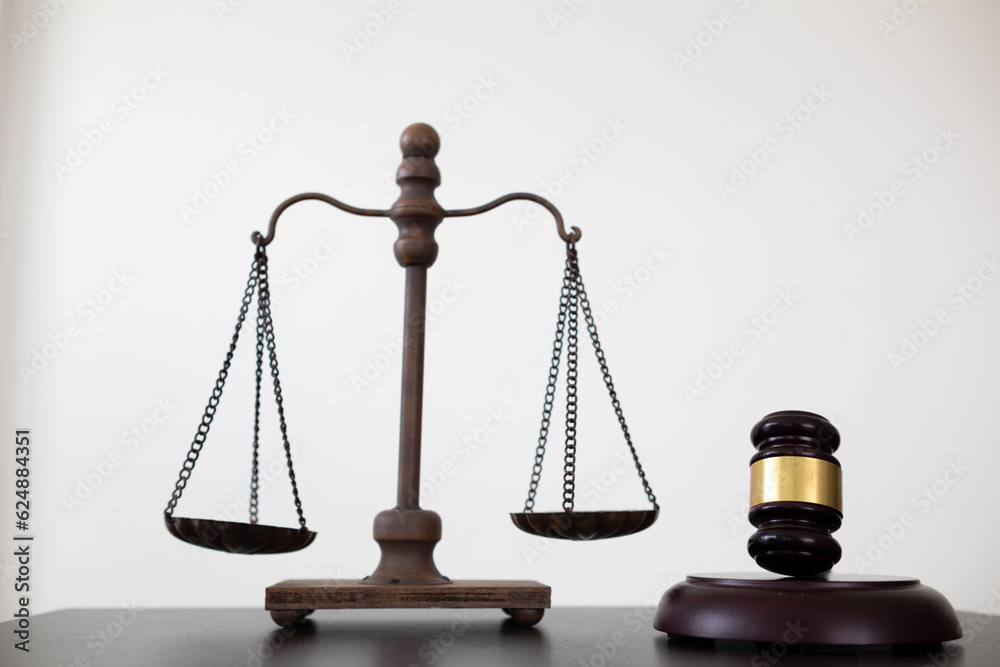 gavel wood and Brass court scales are used to decorate a table in a ...
