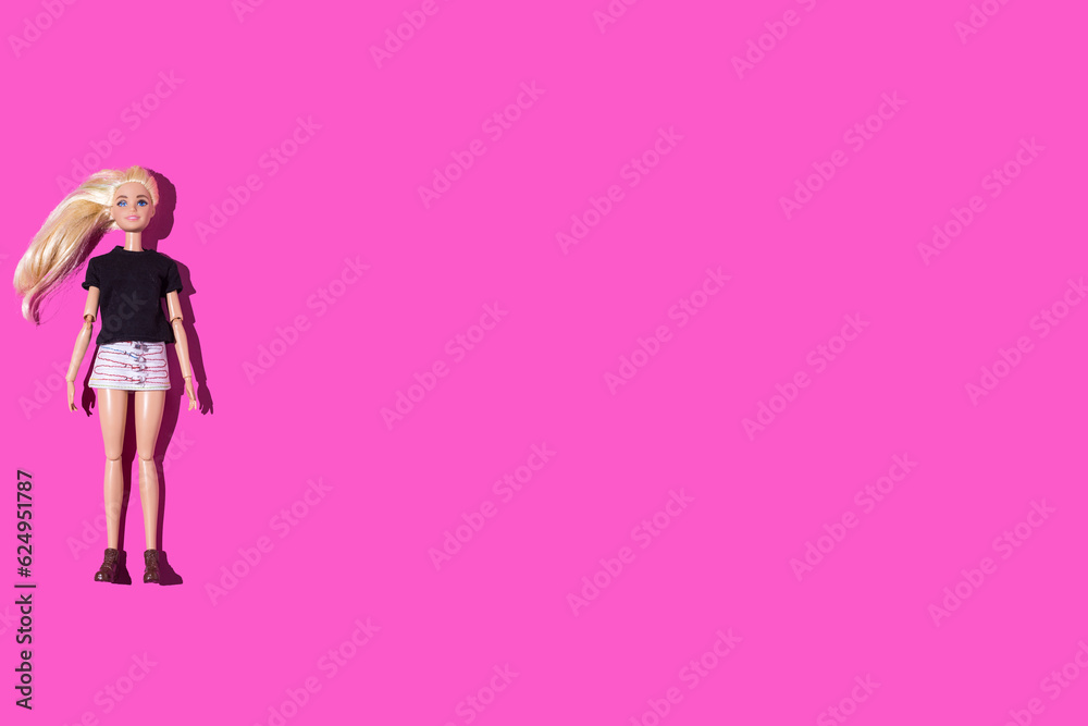 Mattel Barbie doll with black t-shirt and skirt, on the left side, on ...