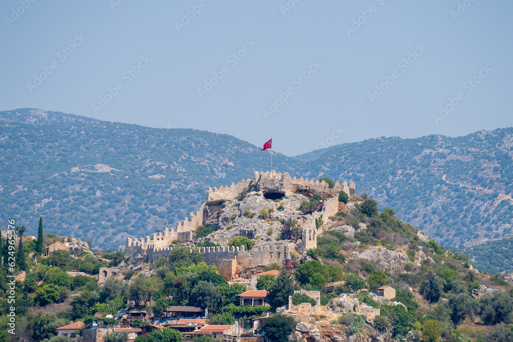 The view of Kalekoy town from Kekova Bay. Simena Castle is located on ...