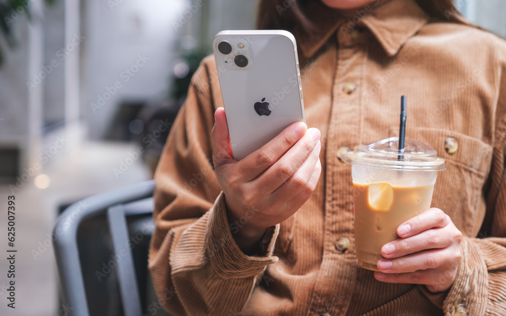Jun 21th 2023 : A woman using on Iphone 13 smart phone screen while ...