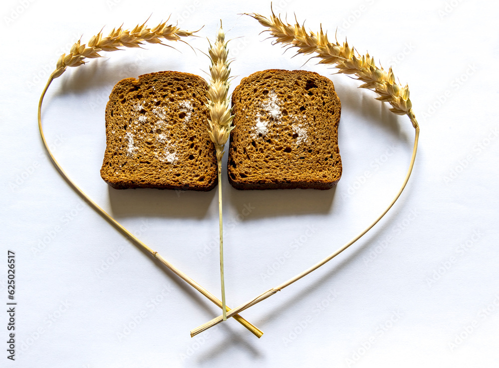 Ears of beardless wheat with black bits of bread and bites of salt as ...