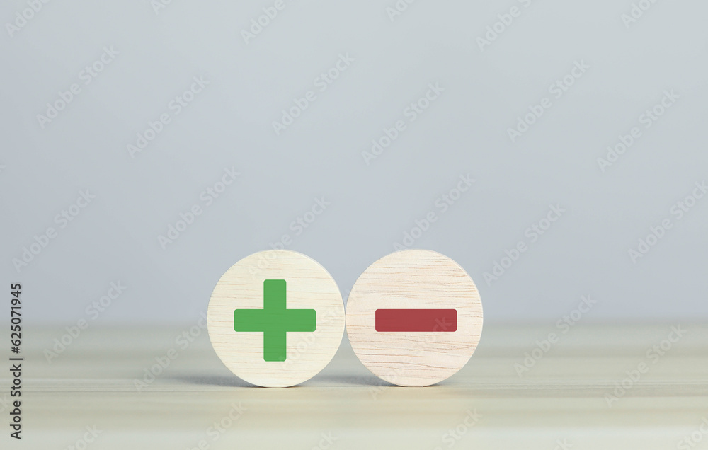 Wooden blocks showing plus and minus signs. The concept of antithesis ...