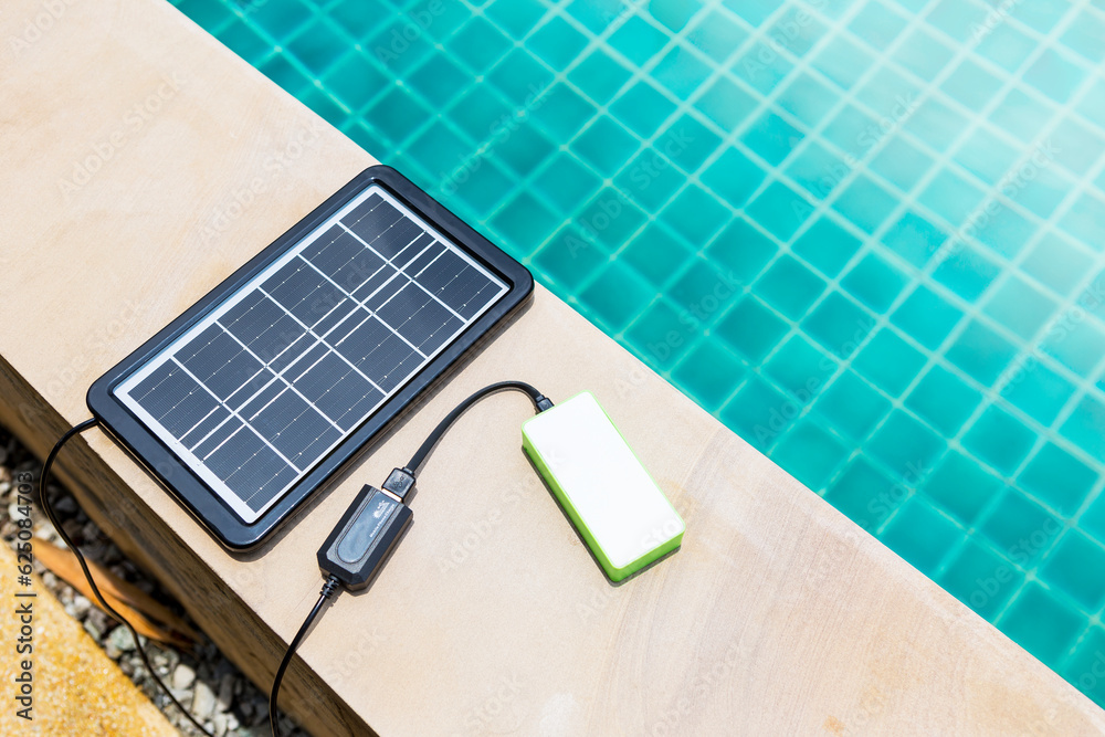 Portable solar cell panel with space on pool water background, clean ...