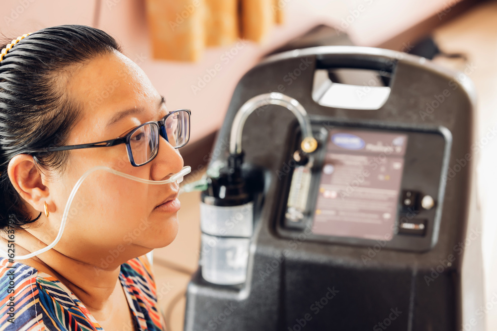 Patients woman wear oxygen inhaler device for helping breath ...