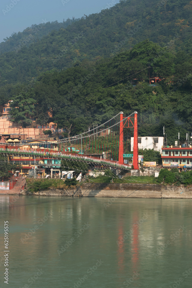 Vertical view of rishikesh ram jhula bridge with mountains and ganga ...