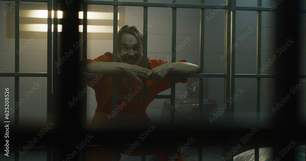 Insane female prisoner in orange uniform yells at neighbor inmate ...