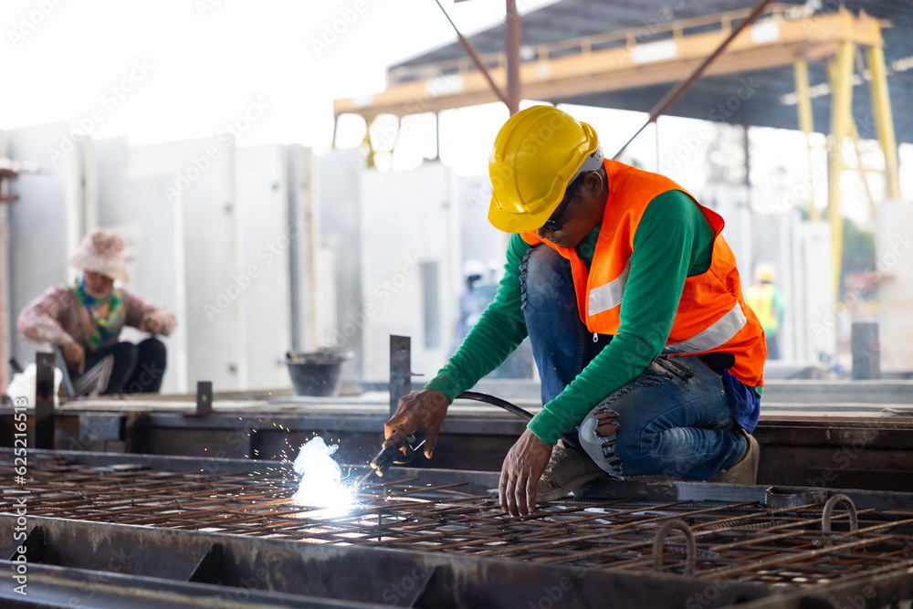 welding. Asian man worker weld metal with a arc welding machine at the ...