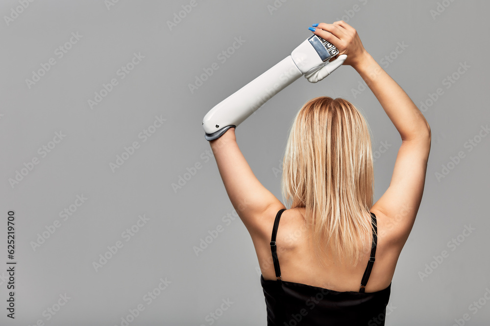 Studio portrait of beautiful young blonde girl with disability wearing ...