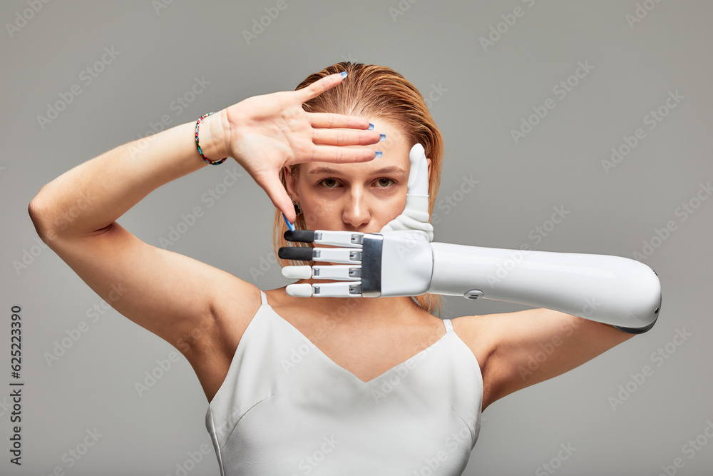 Studio portrait of a young girl with disability wearing sensory bionic ...