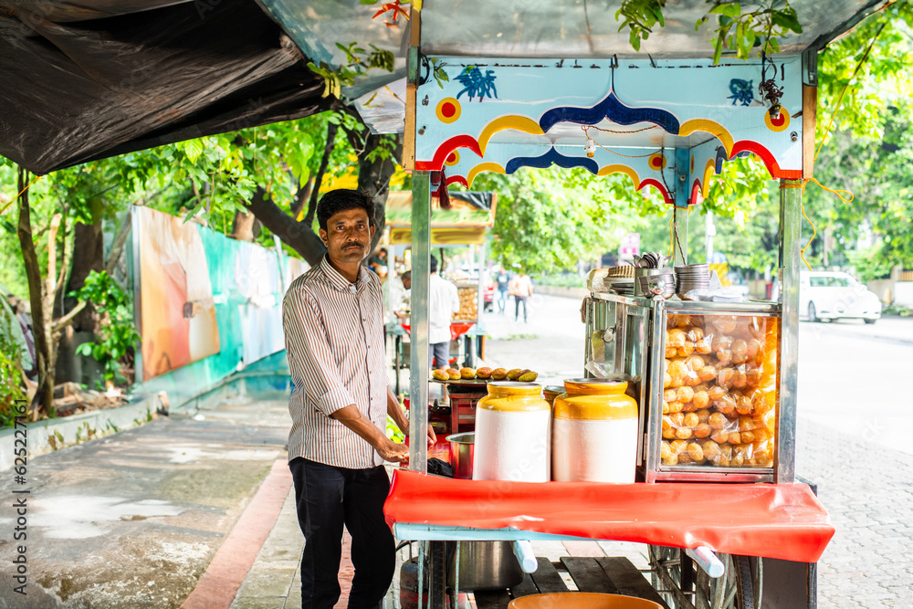 panipuri shop -happy young male Indian roadside vendor selling golgappe ...
