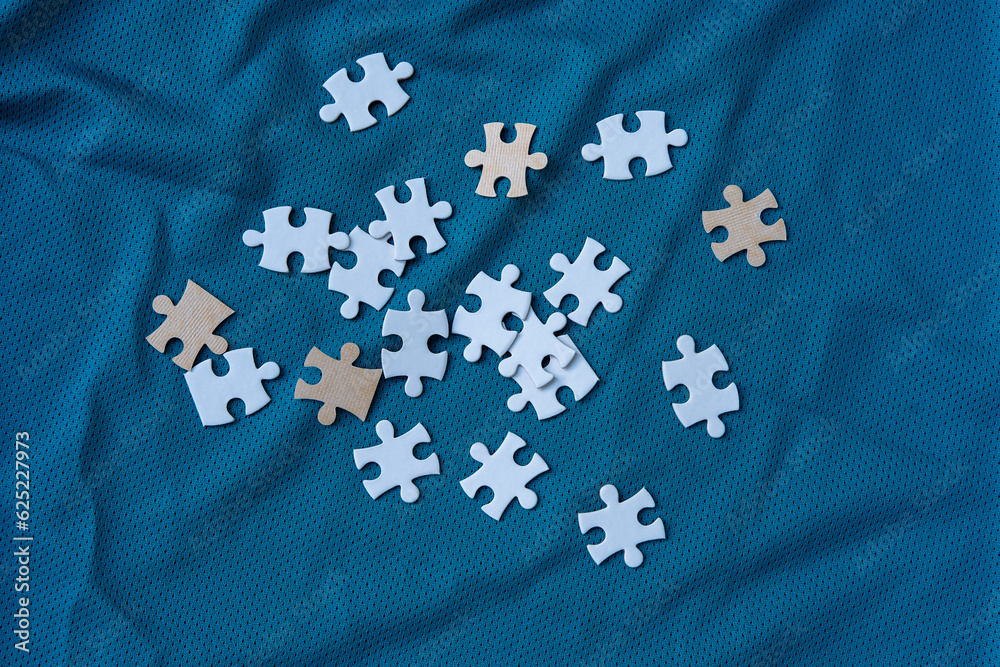 Jigsaw puzzle white color pieces on Colorful athletic Jersey texture ...
