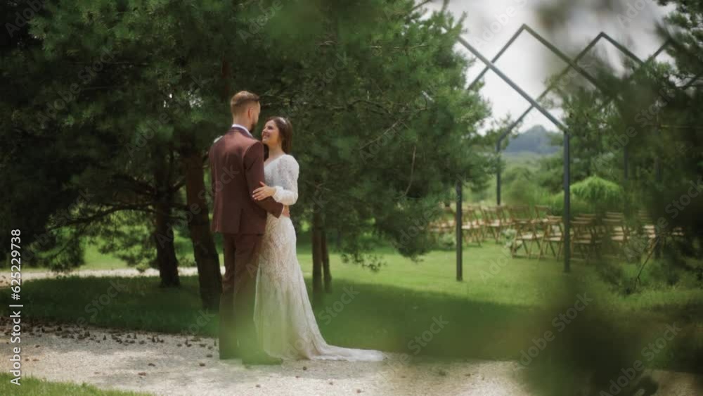 Just meried couple standing in the forest of pine trees. The bride and ...