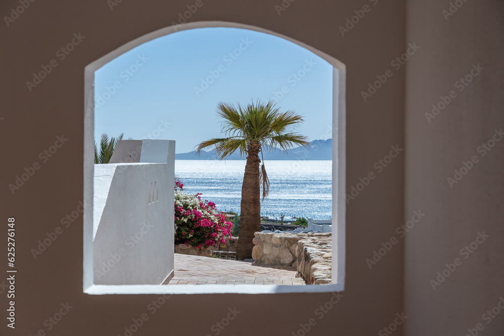 Window hole in the white stone wall of a building overlooking the Red ...
