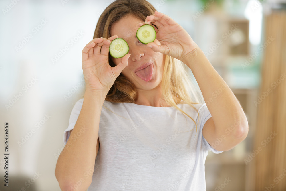 young model covering eyes with cucumber Stock Photo | Adobe Stock