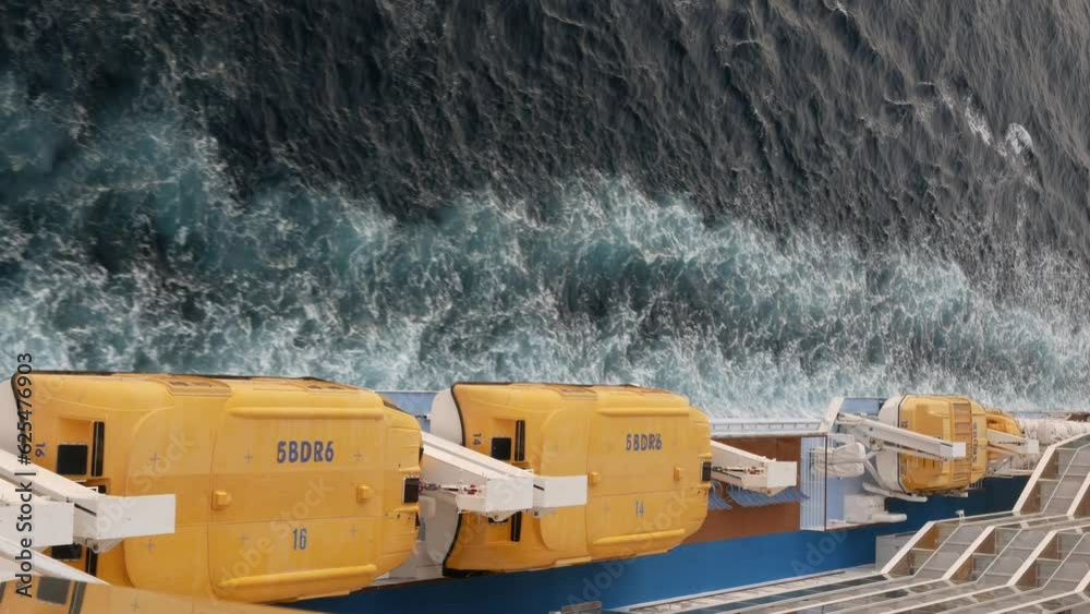 Vertical view of Lifeboat on giant cruise ship view down to ocean ...