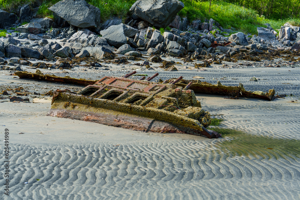 Remains of a sunken ship. wrecked cargo ship in Norway fjord. The ...