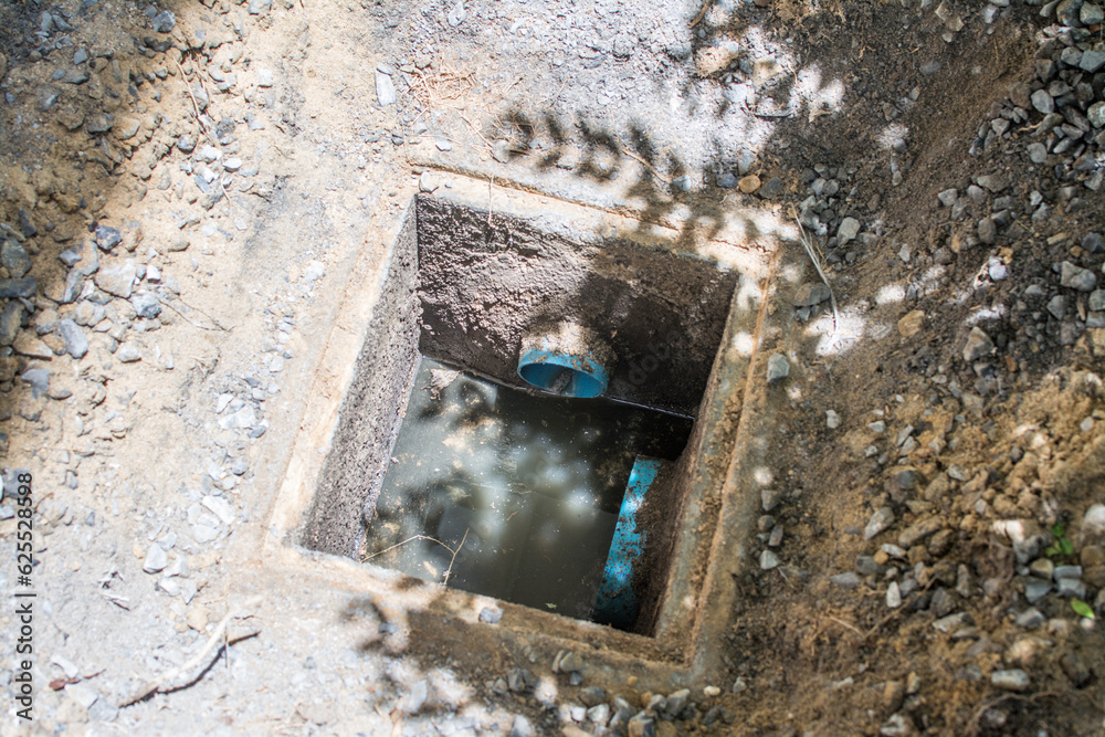 installing concrete manhole with drain pipes at construction site Stock ...