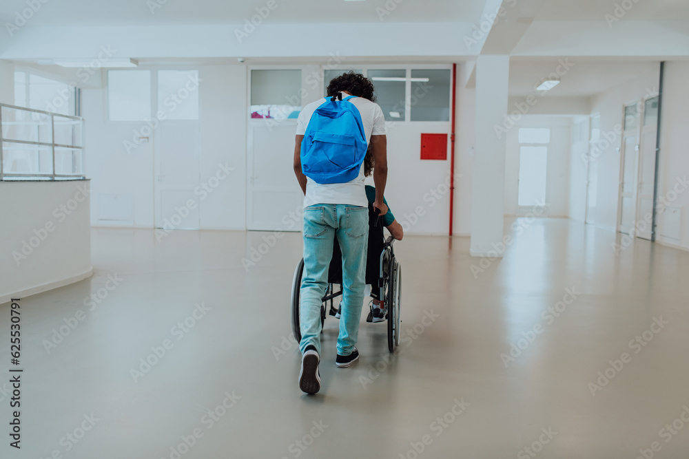 African American student pushing his friend's wheelchair through a ...