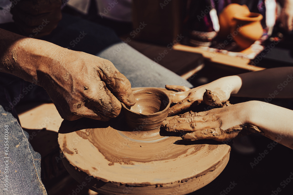 Teaching pottery to children. A master teaches a child pottery ...