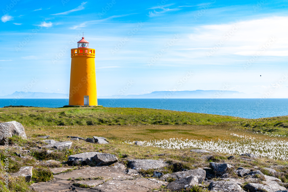 Holmsberg Lighthouse, an orange light house on the Reykjanes Peninsula ...