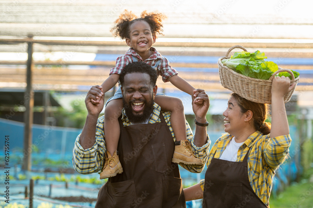 Happy farmer parents dad father with daughter child on piggyback ...