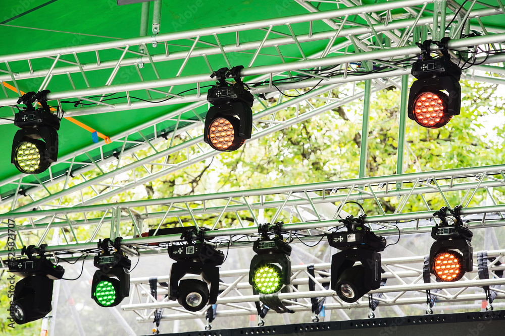 Stage lighting on a mobile concert stage. LED spotlights on a metal ...