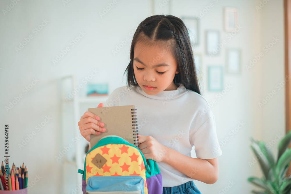 Pupil child put books and notes into backpack. School supplies.Back to ...
