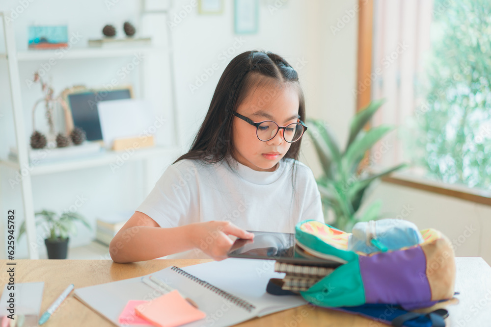Pupil child put books and notes into backpack. School supplies.Back to ...